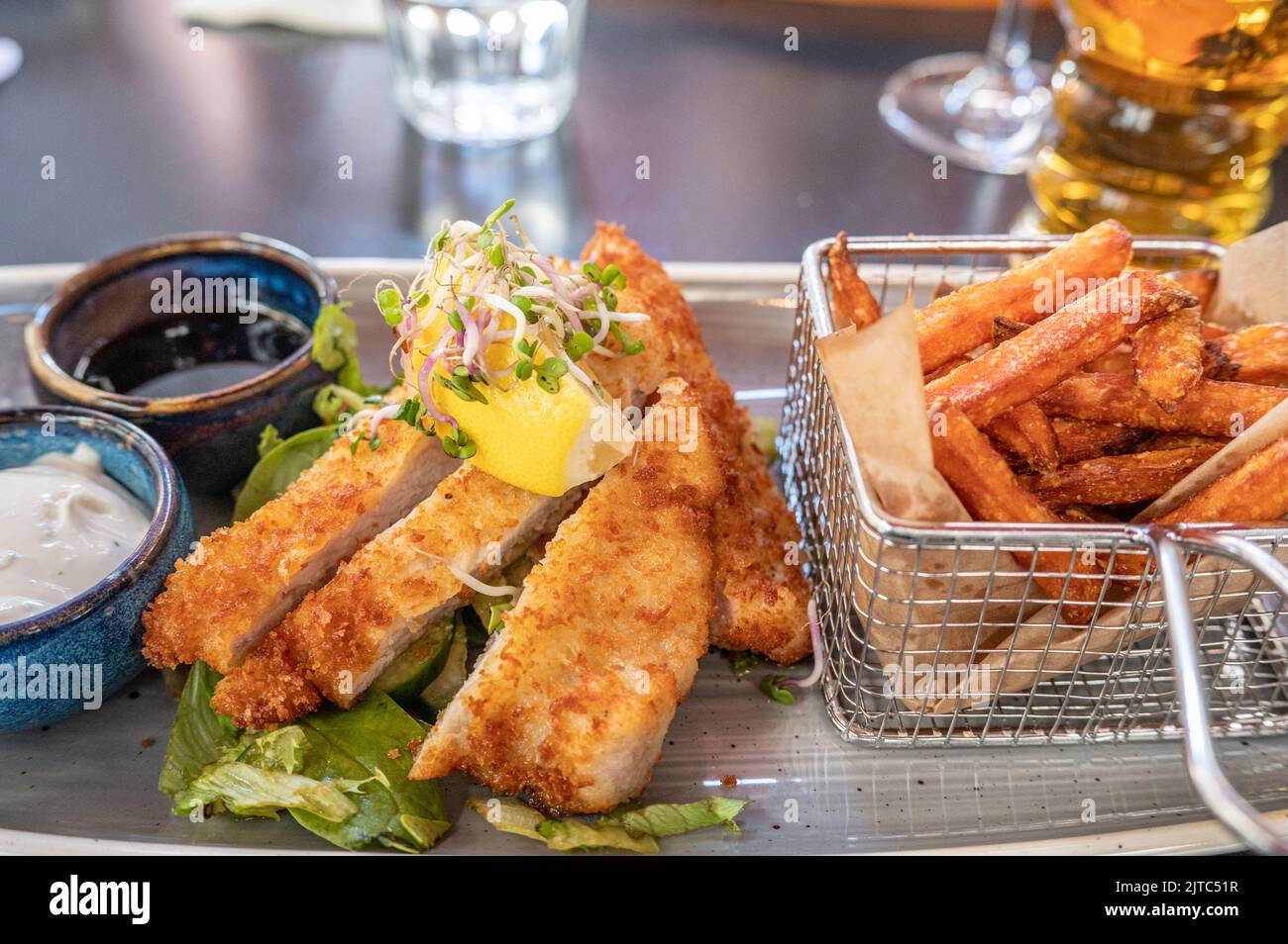 Tonkatsu served with sweet potato fries and aioli. Tonkatsu is a ...