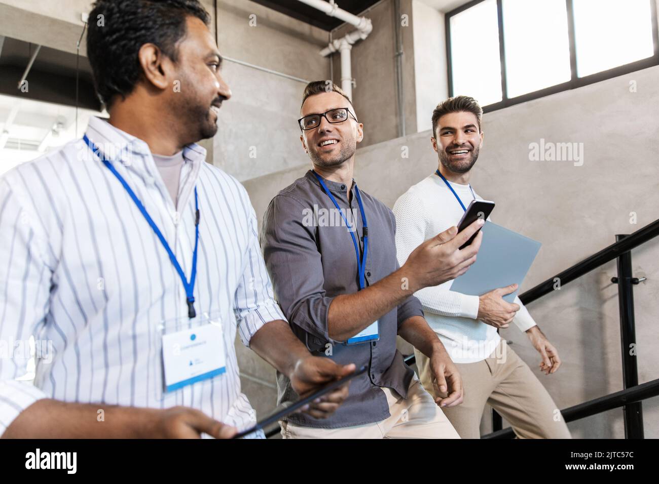 Businessman walking up staircase smartphone hi-res stock photography ...