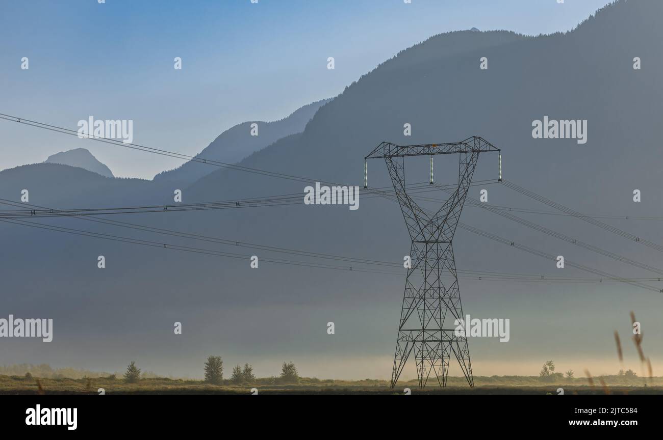 High-voltage power lines at sunrise in foggy morning,high voltage electric transmission tower ...