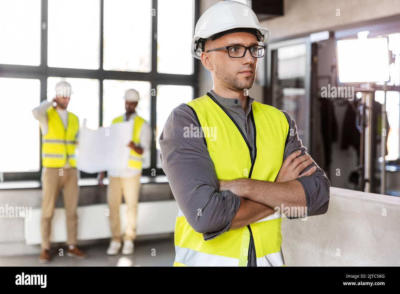 male architect in helmet and safety west at office Stock Photo - Alamy