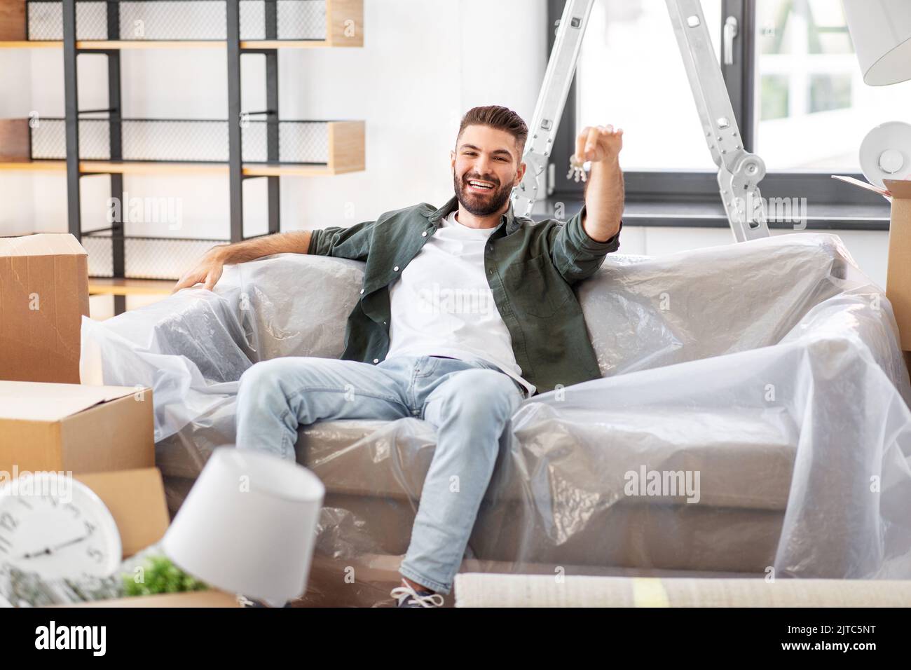 man with house keys and boxes moving to new home Stock Photo - Alamy
