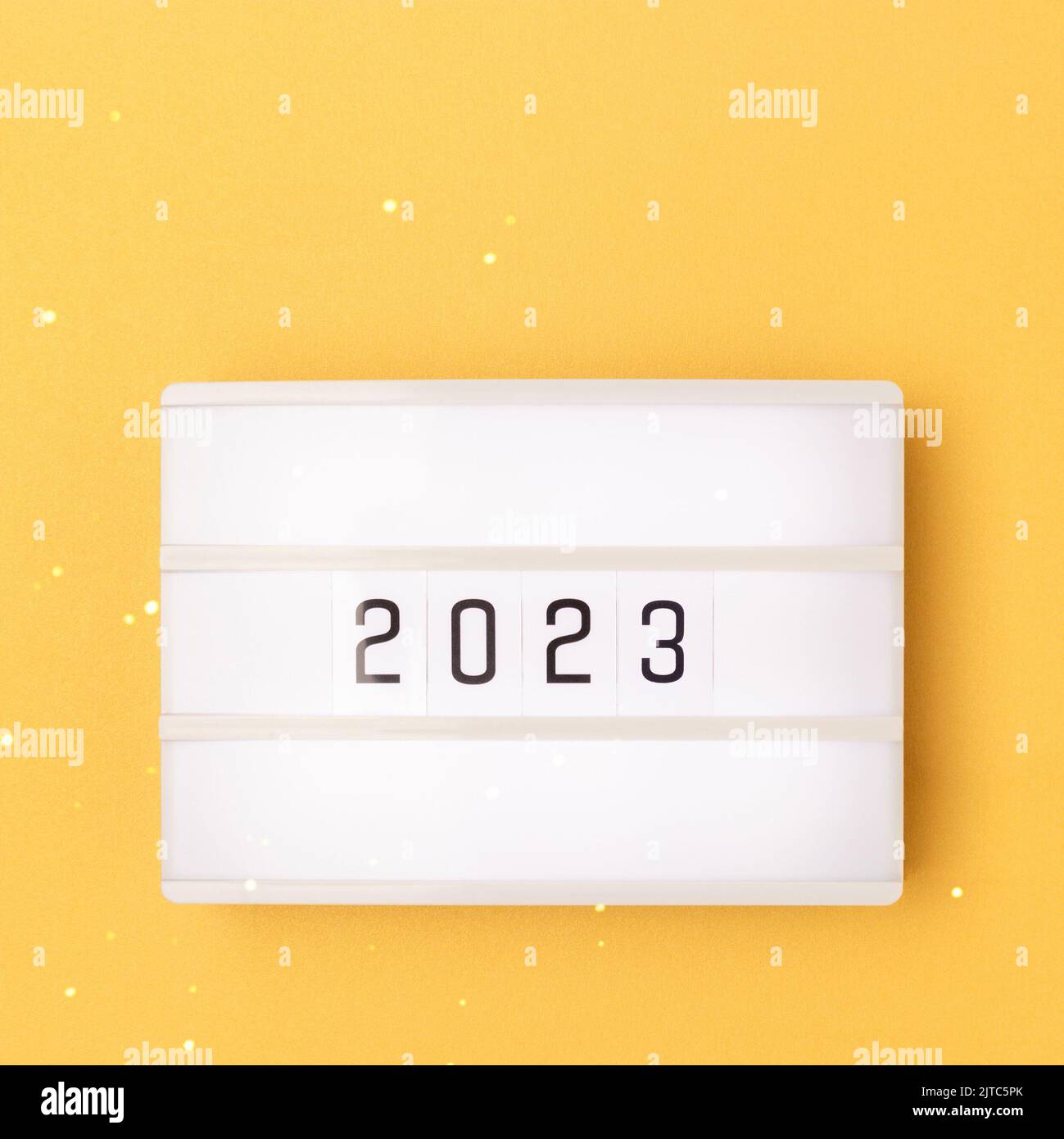 White lightbox with 2023 numbers on a golden background with copy space ...