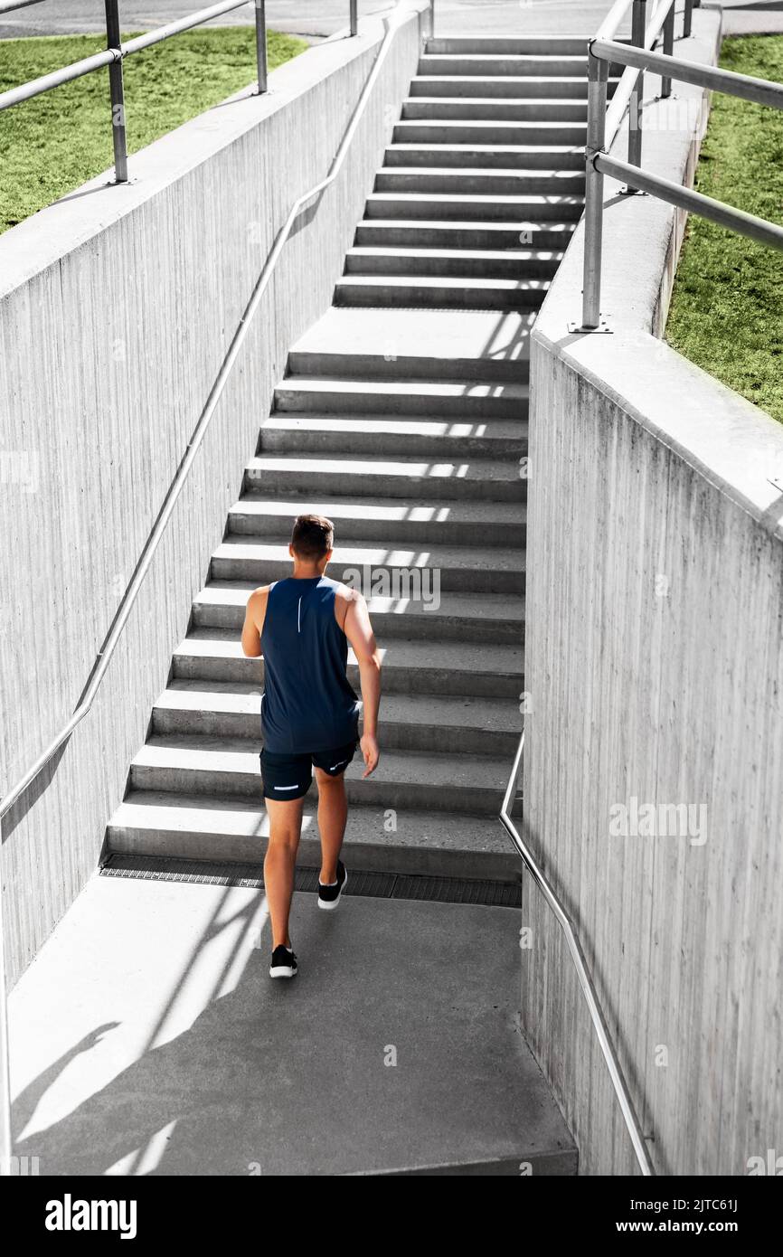 young man running upstairs Stock Photo - Alamy