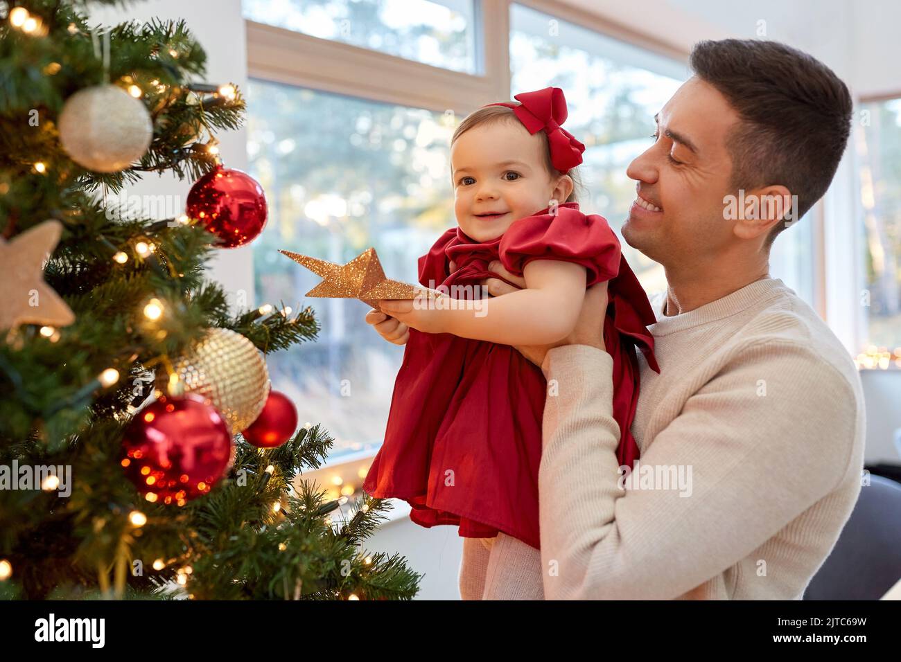 happy father and baby girl decorate christmas tree Stock Photo - Alamy