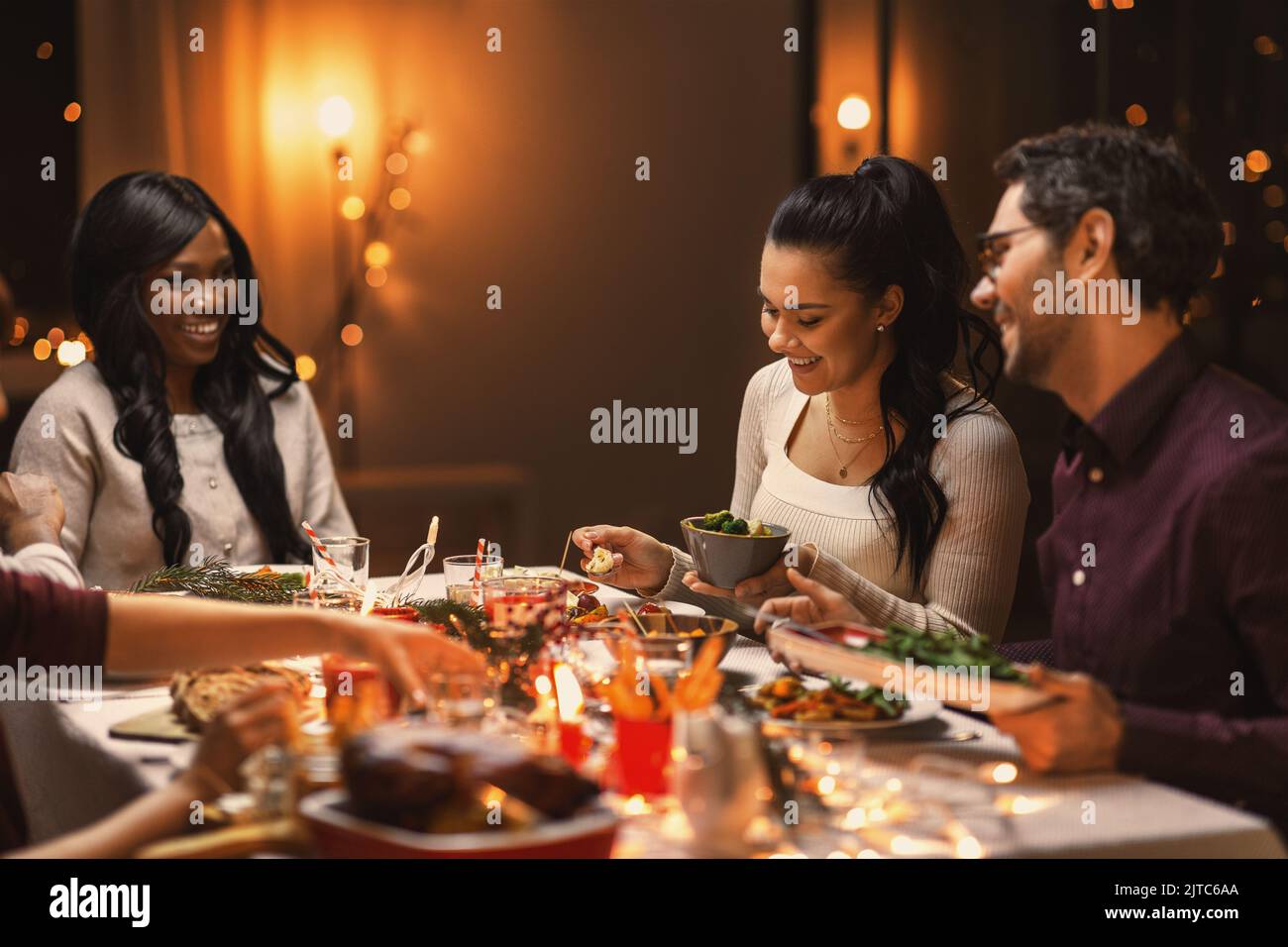 happy friends having christmas dinner at home Stock Photo - Alamy