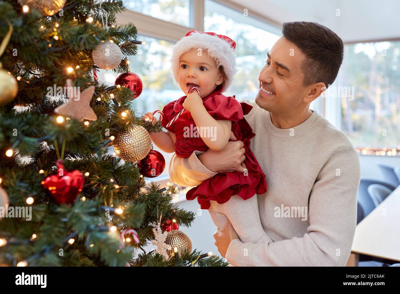 happy father and baby girl decorate christmas tree Stock Photo - Alamy