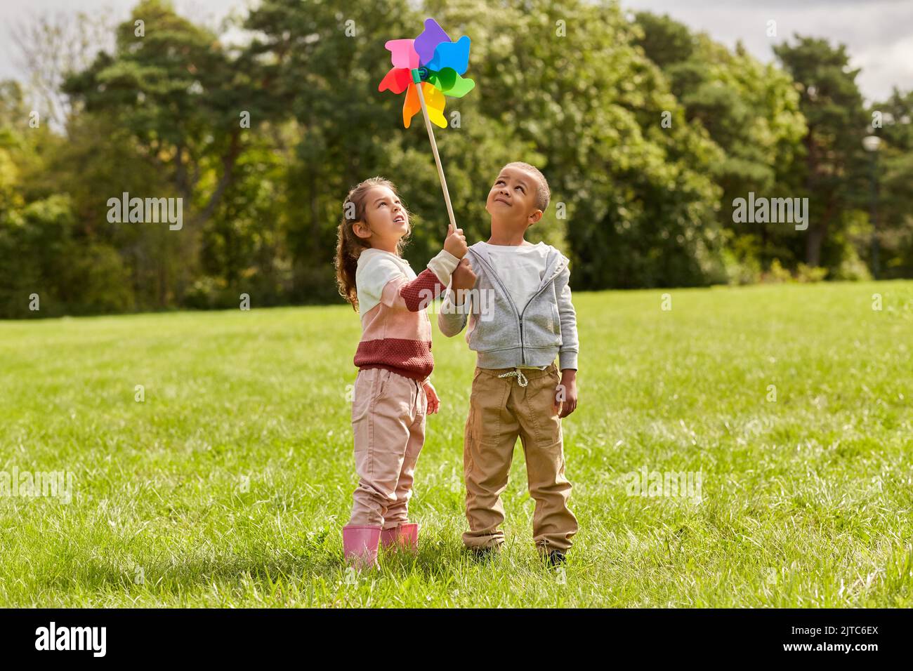happy kids with pinwheel having fun at park Stock Photo - Alamy