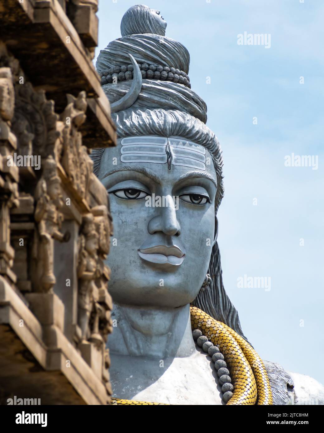 A vertical shot of the Shiva statue with a sky background Stock Photo ...