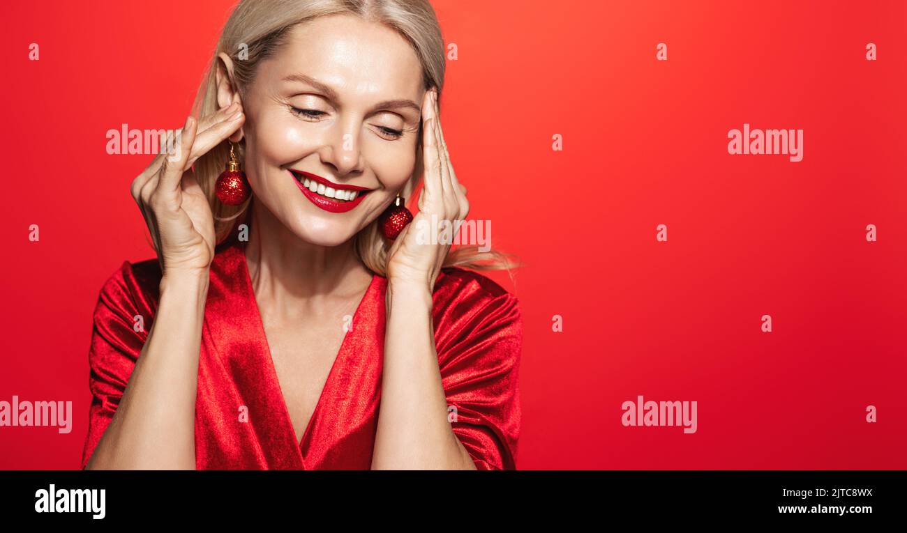 Beautiful gorgeous 50s mid aged mature woman looking at camera isolated ...