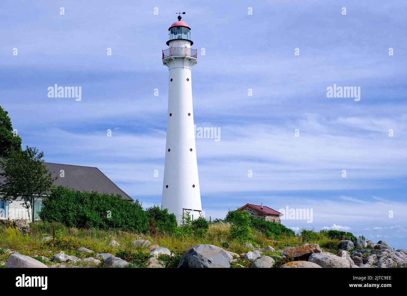 Beautiful lighthouse near the sea in a small village in clear weather ...