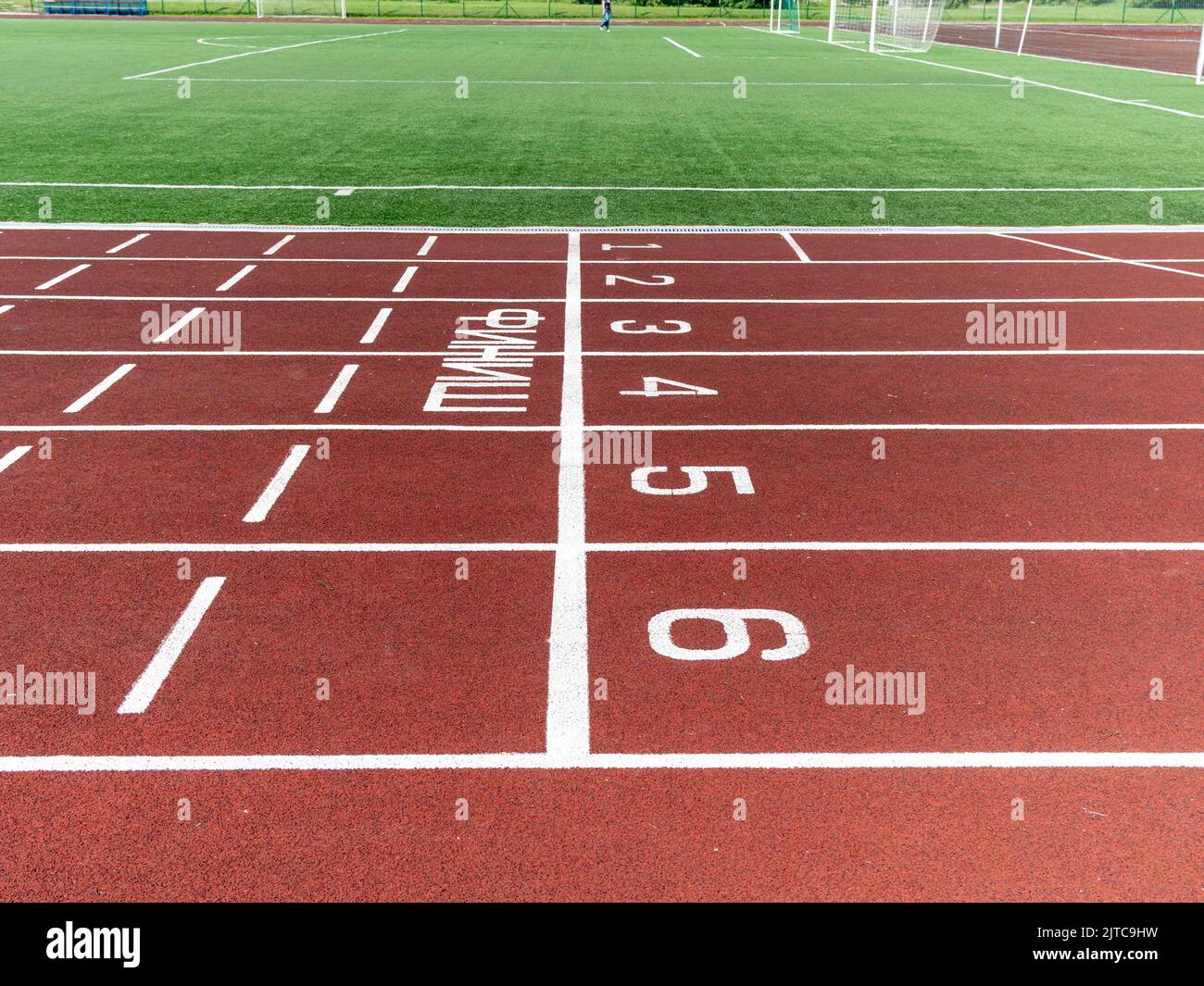 Red treadmill at the stadium with white lines Stock Photo - Alamy