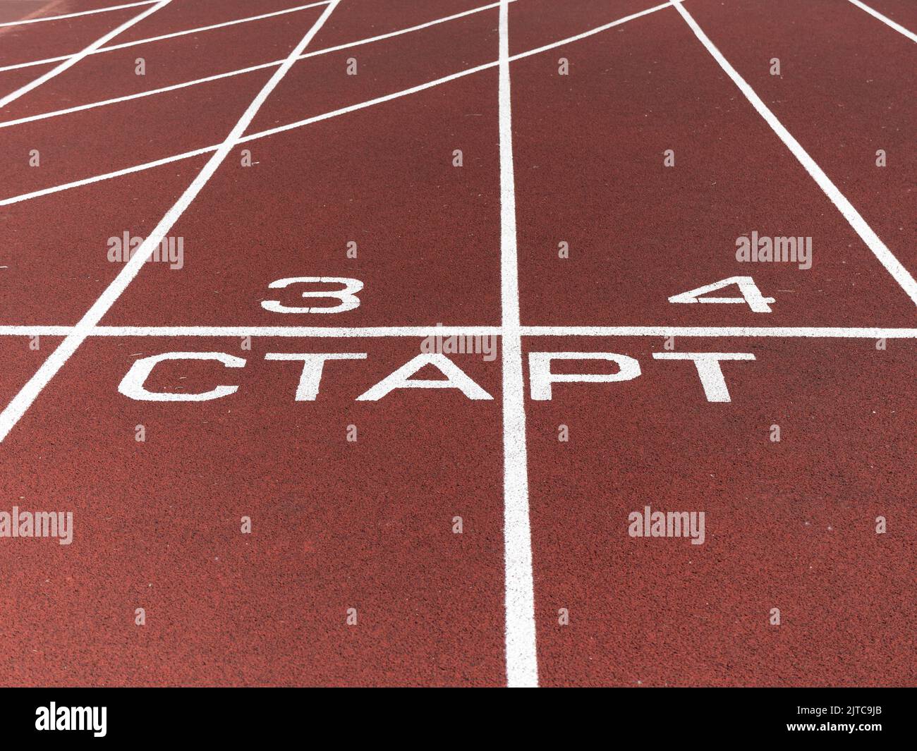 Red treadmill at the stadium with white lines Stock Photo - Alamy