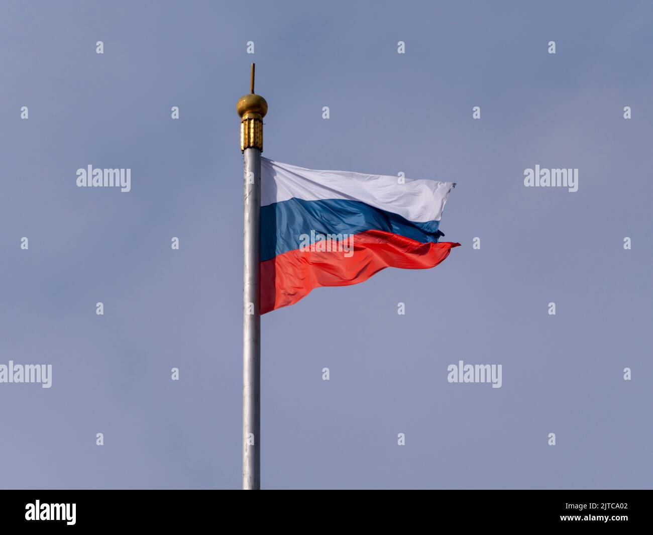 Russian flag fluttering in the wind on a flagpole Stock Photo - Alamy