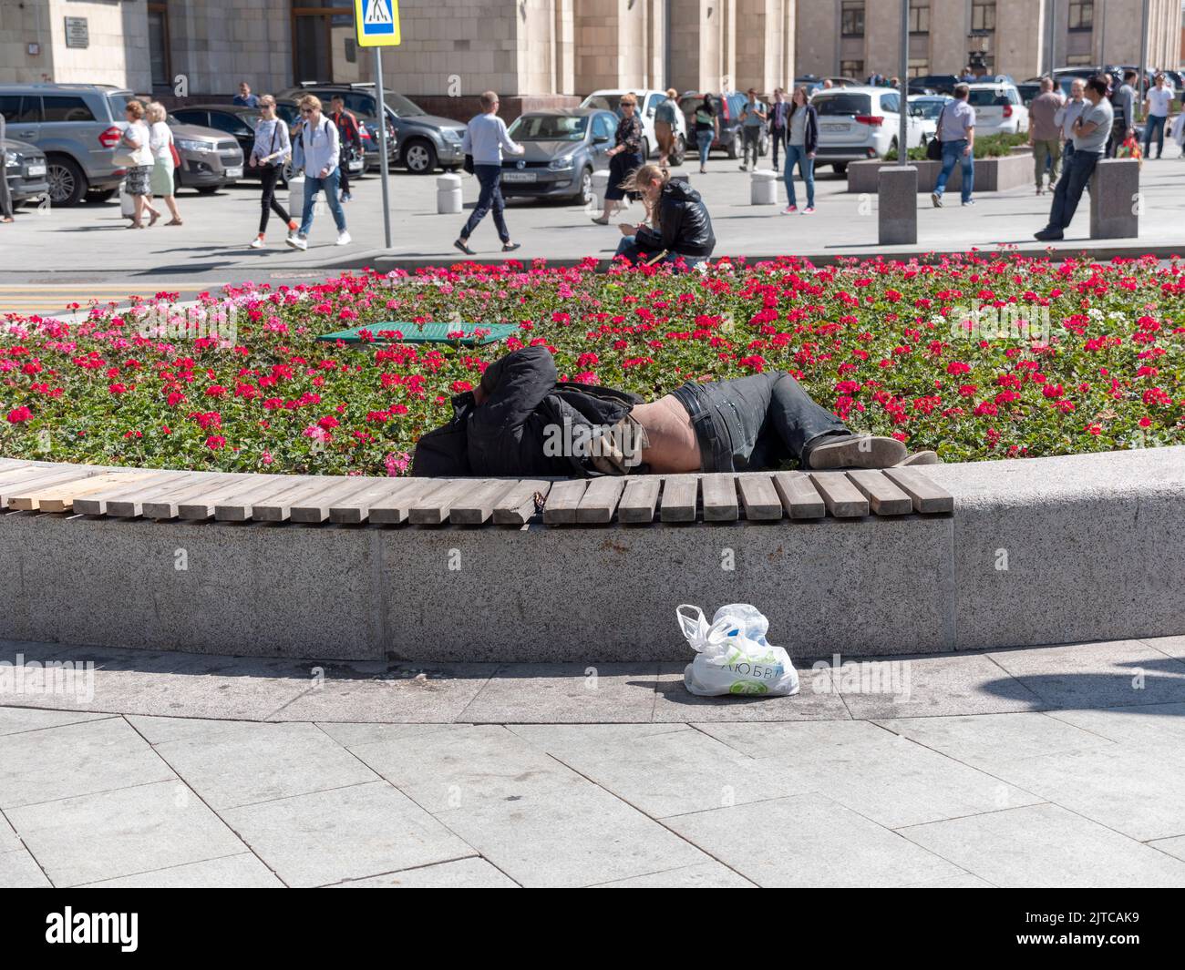 Moscow, Russia - August, 28, 2021: homeless beggar sleeps on the bench ...