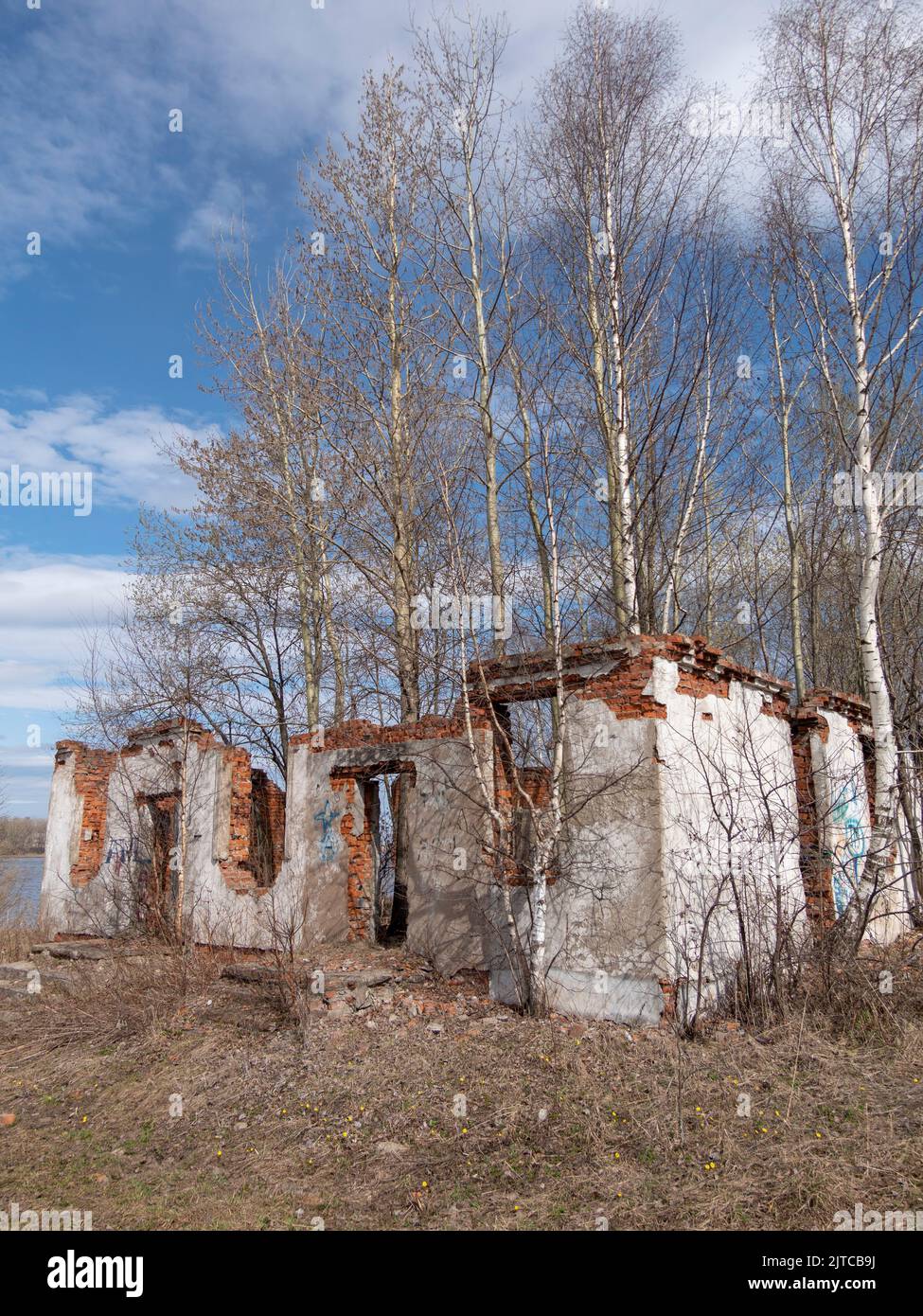 Burnt wooden country house with a brick pipe Stock Photo - Alamy
