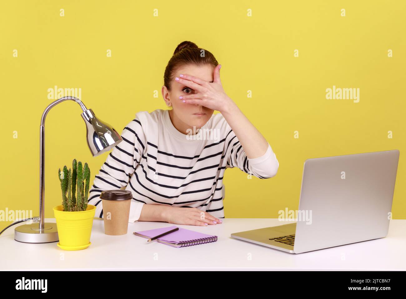Curious woman manager sitting at workplace with laptop and spying ...