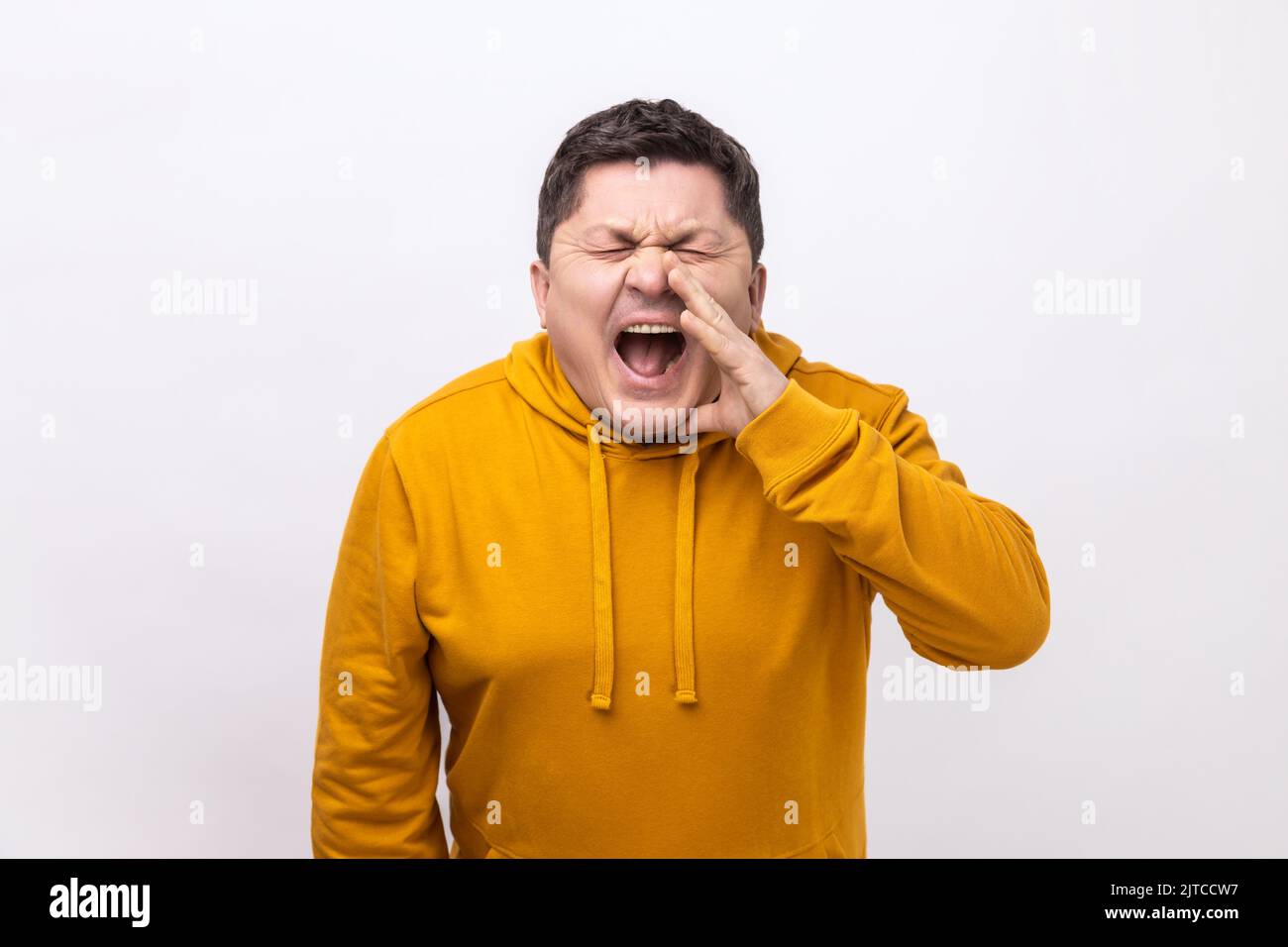 Angry nervous middle aged man loudly yelling widely opening mouth ...