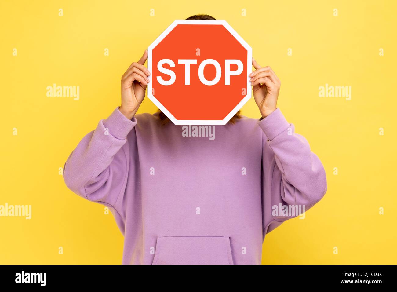 Unknown woman covering face with Stop symbol, anonymous person holding ...