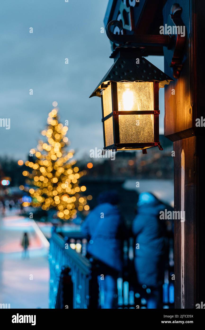 Vertical Christmas market lantern light with burred background with ...
