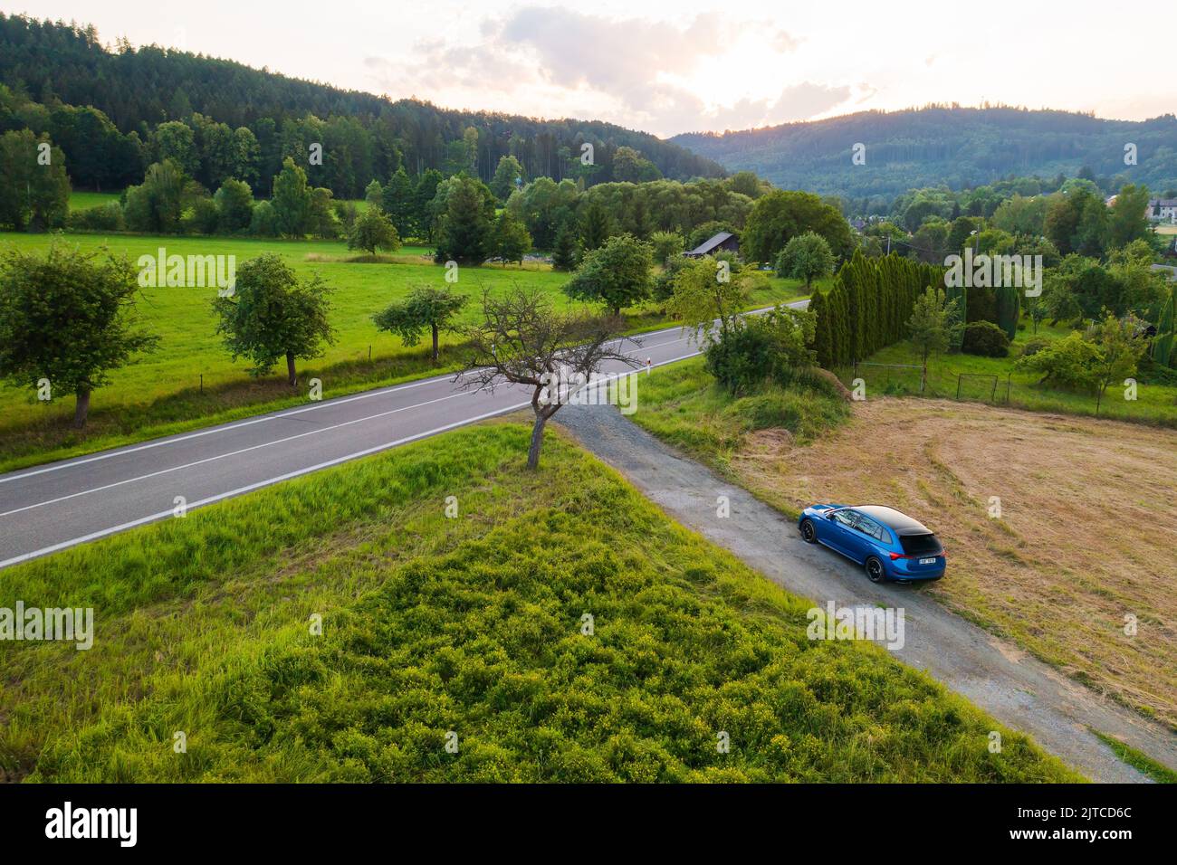 Blue Skoda Scala car standing on the countryside road with amazing view ...