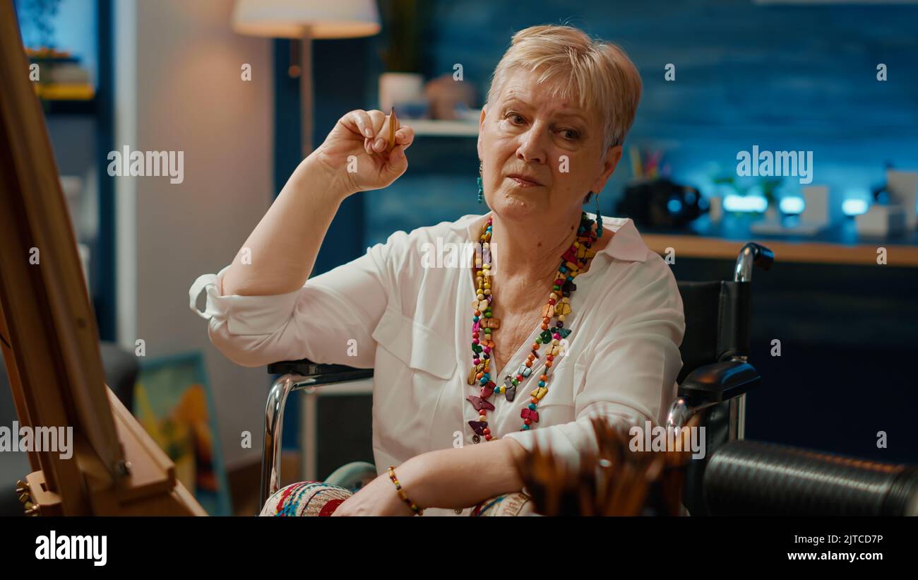 Old woman living with physical disability and drawing masterpiece on ...