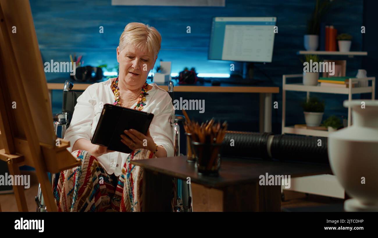 Wheelchair user with health condition using tablet to find inspiration ...