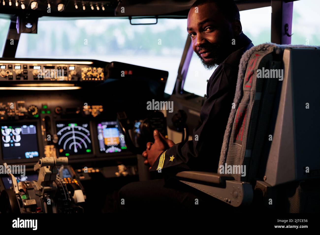 Portrait of african american pilot using dashboard command in cabin to ...