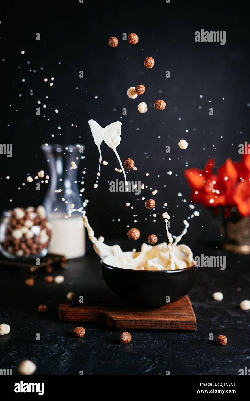 Magical breakfast with flying cereal and milk splashes Stock Photo - Alamy