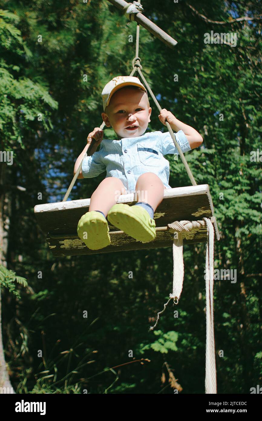 Little boy on a swing Stock Photo - Alamy