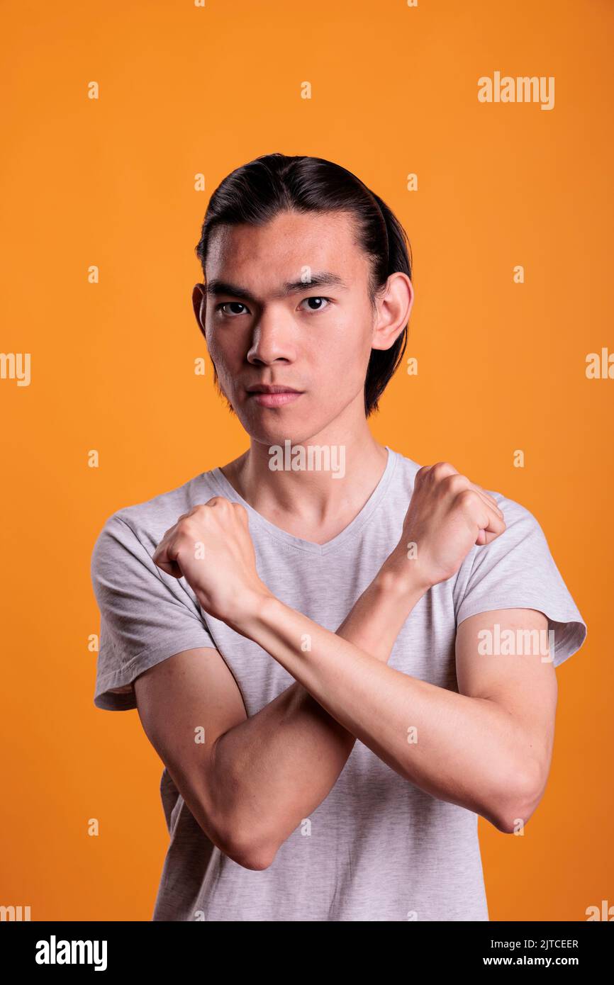 Confident young asian man showing stop gesture portrait, rejection ...