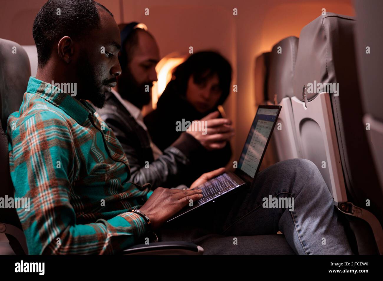 Male passenger travelling abroad by airplane on international flight ...
