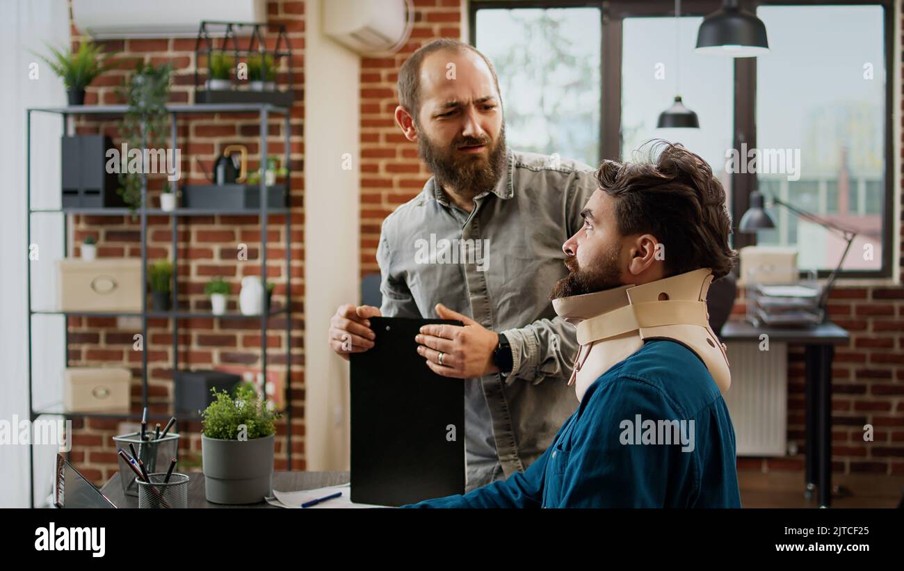Hurt company employee with cervical collar after physical accident ...