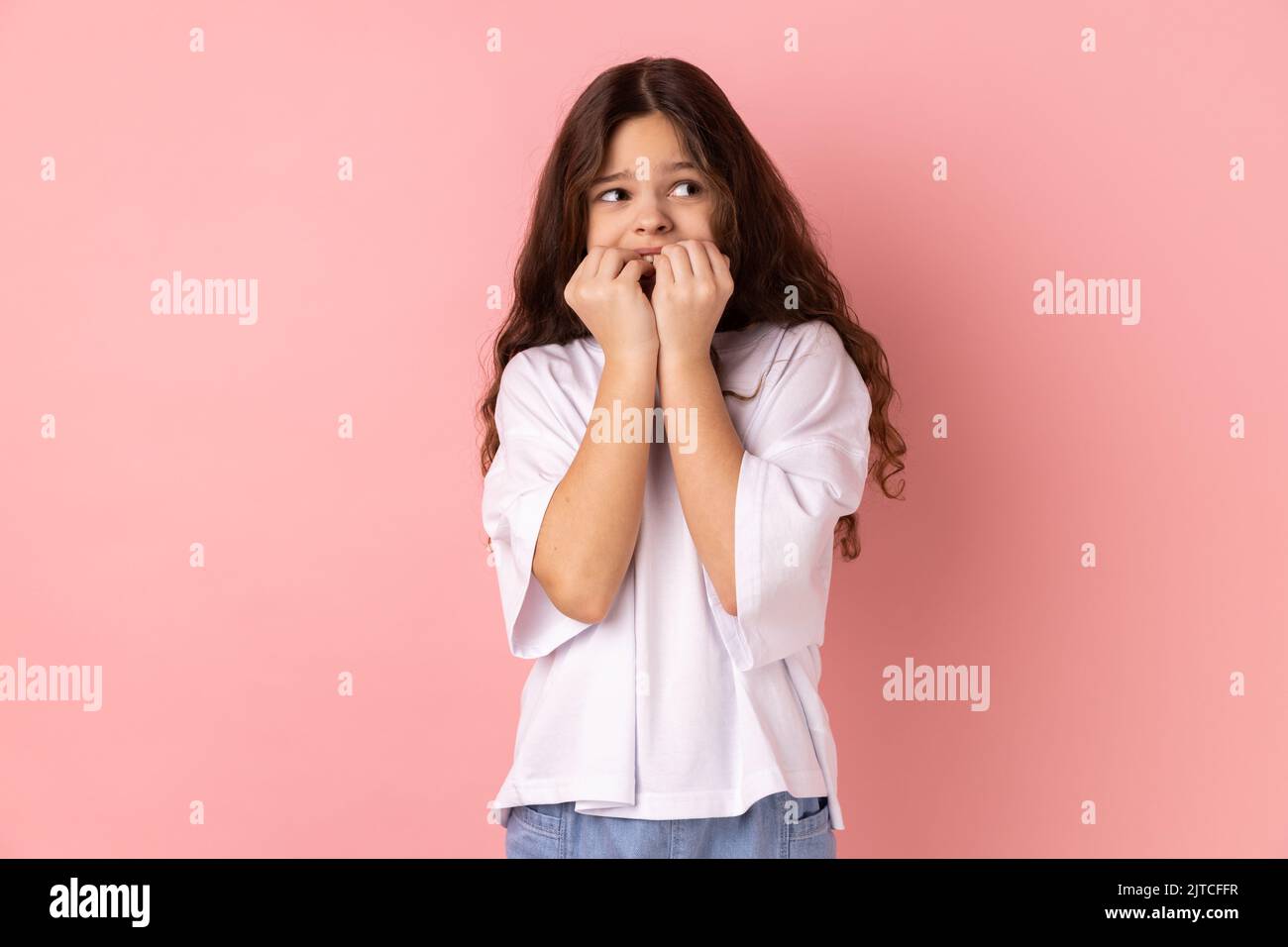 Troubles and worries. Portrait of little girl wearing white T-shirt ...