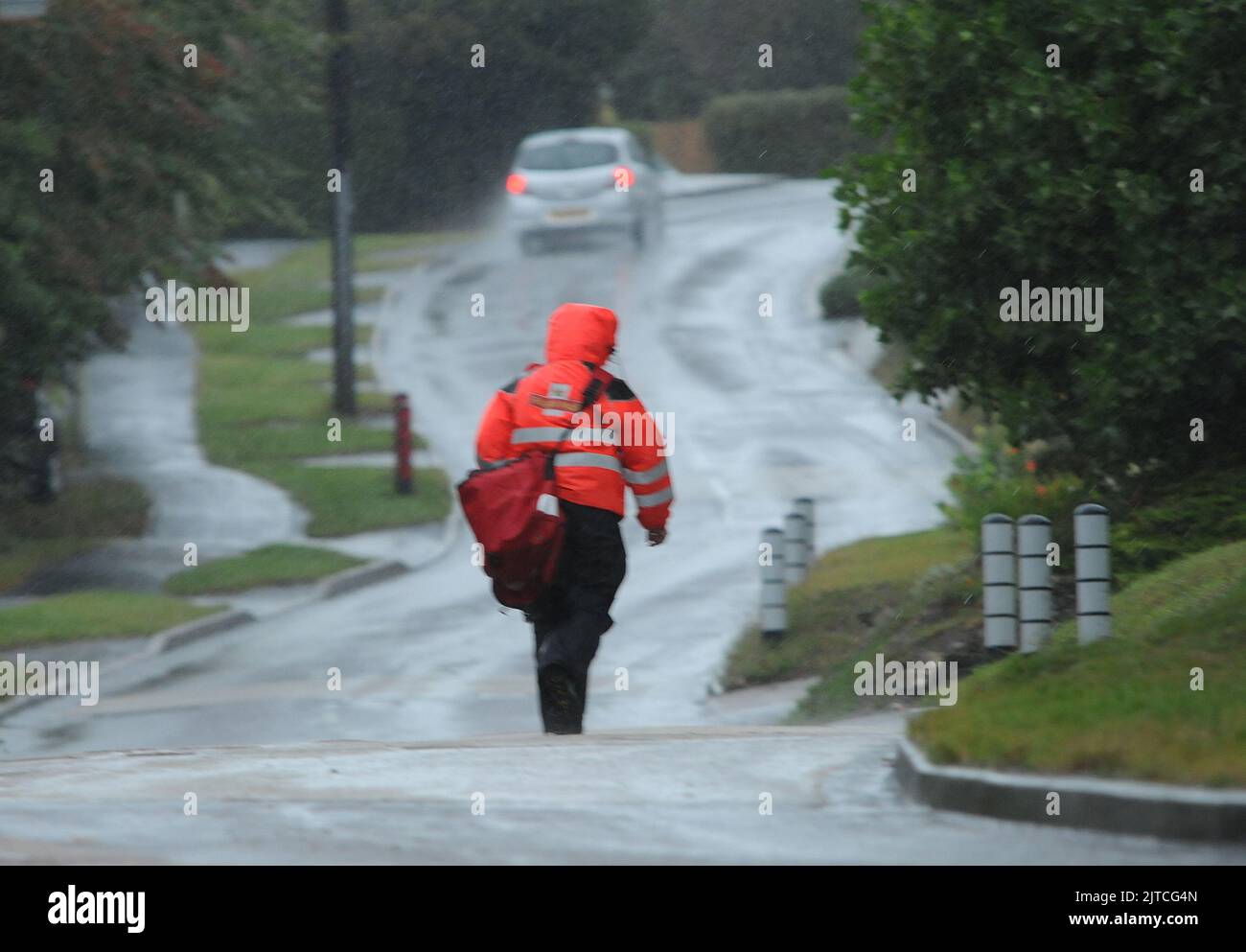 A POSTMAN BATTLES THE WIND AND RAIN AT PORTCHESTER, HANTS. PIC MIKE ...