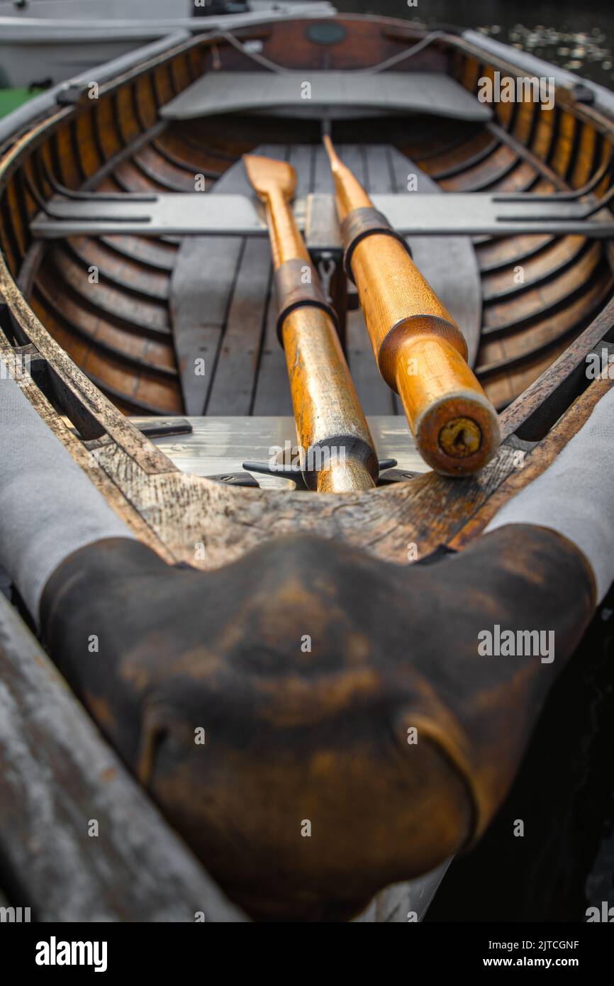 A vertical closeup of a wooden rowboat in harbor in New England Stock ...