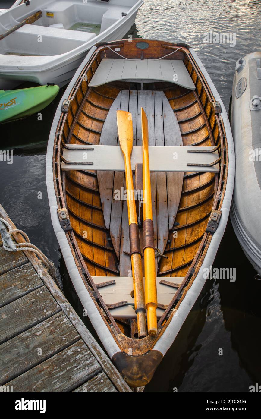 A vertical closeup of a wooden rowboat in harbor in New England Stock ...