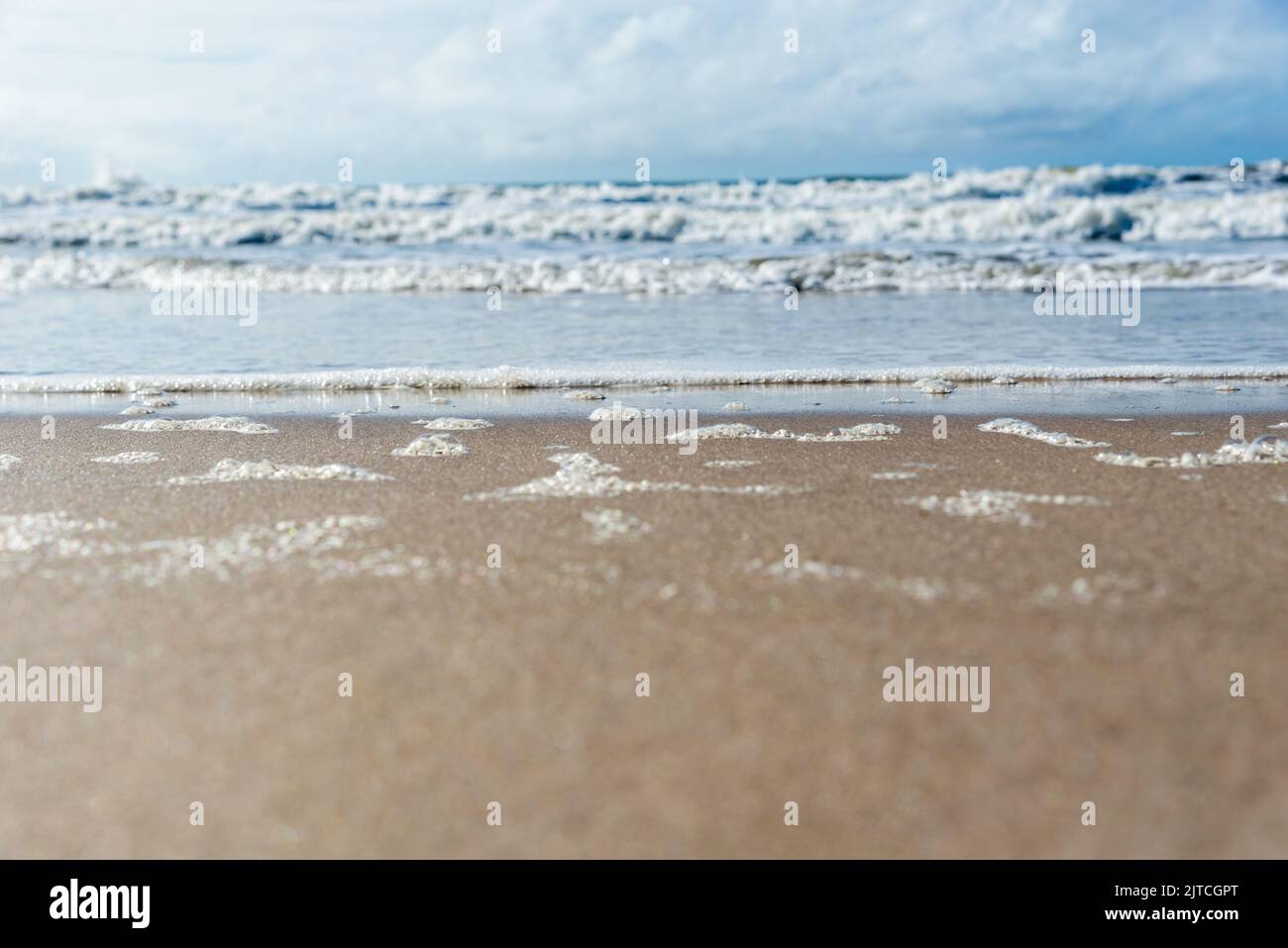 View of the beach sand against the sea and the beautiful blue sky with ...