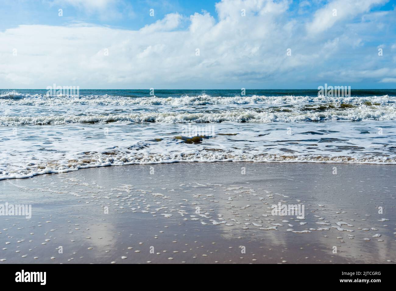 View of the beach sand against the sea and the beautiful blue sky with ...