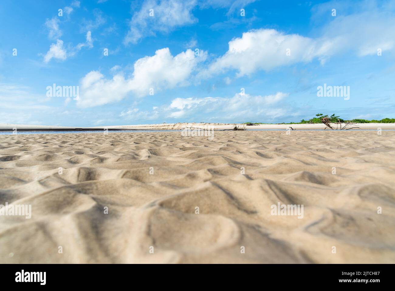 View of the beach sand against the sea and the beautiful blue sky with ...