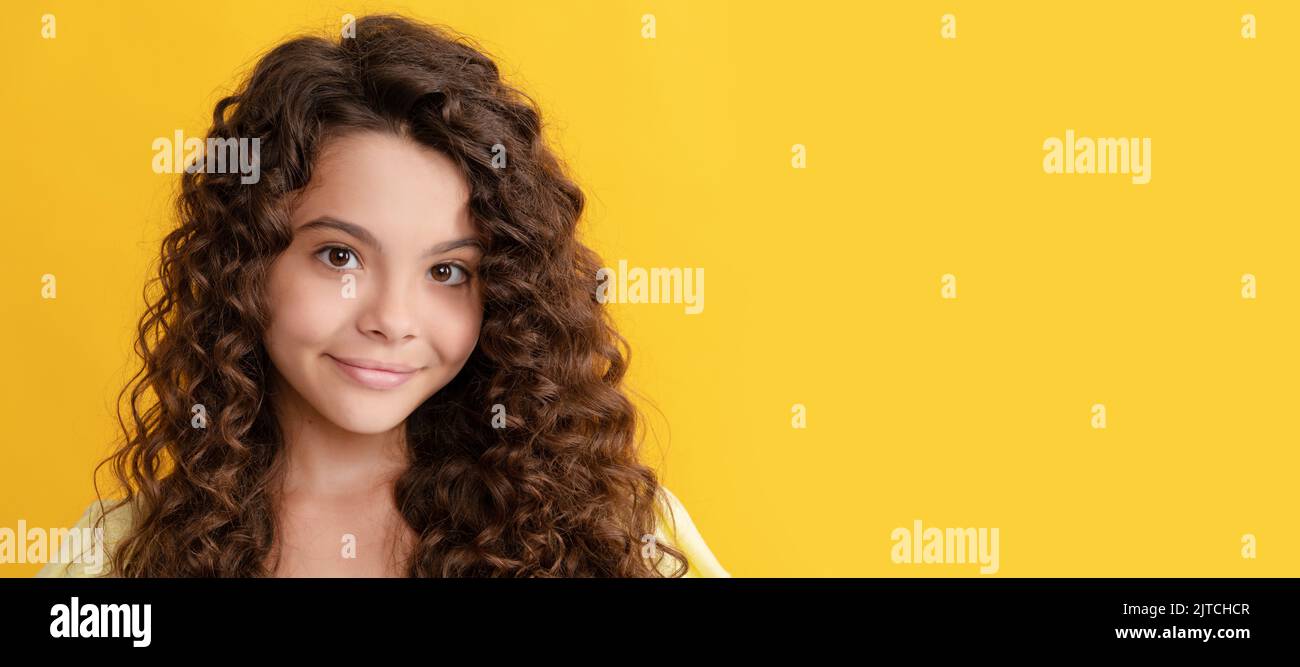smiling kid with long curly hair and perfect skin, frizzy. Child face ...