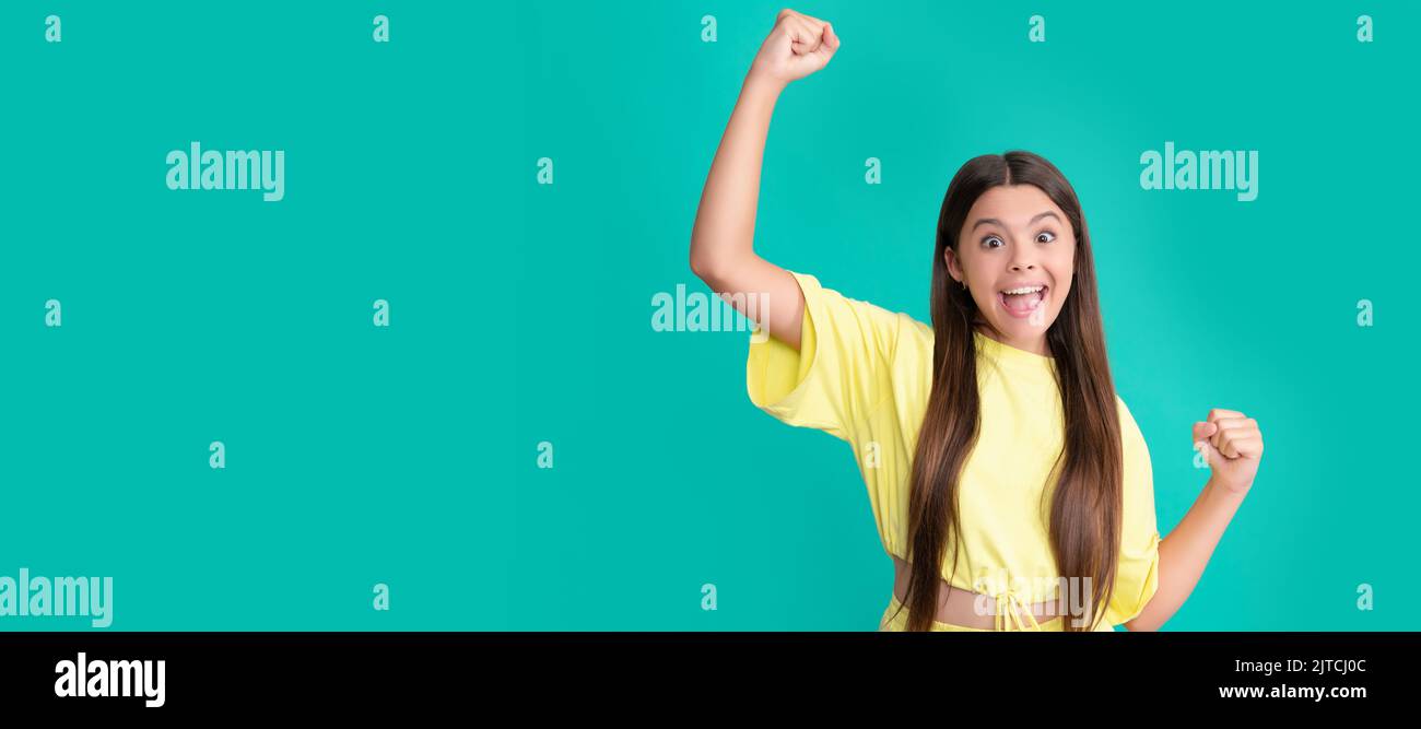 happy successful kid with long hair on blue background, success. Child ...