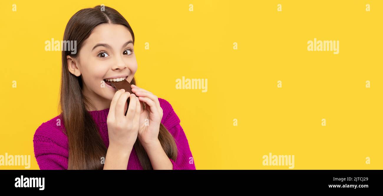 Bite a piece, enjoy a snack. Happy child eat chocolate. Sweet snack ...