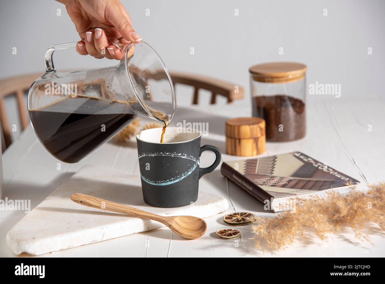ceramic coffee cup with coffee drip pouring over Stock Photo - Alamy