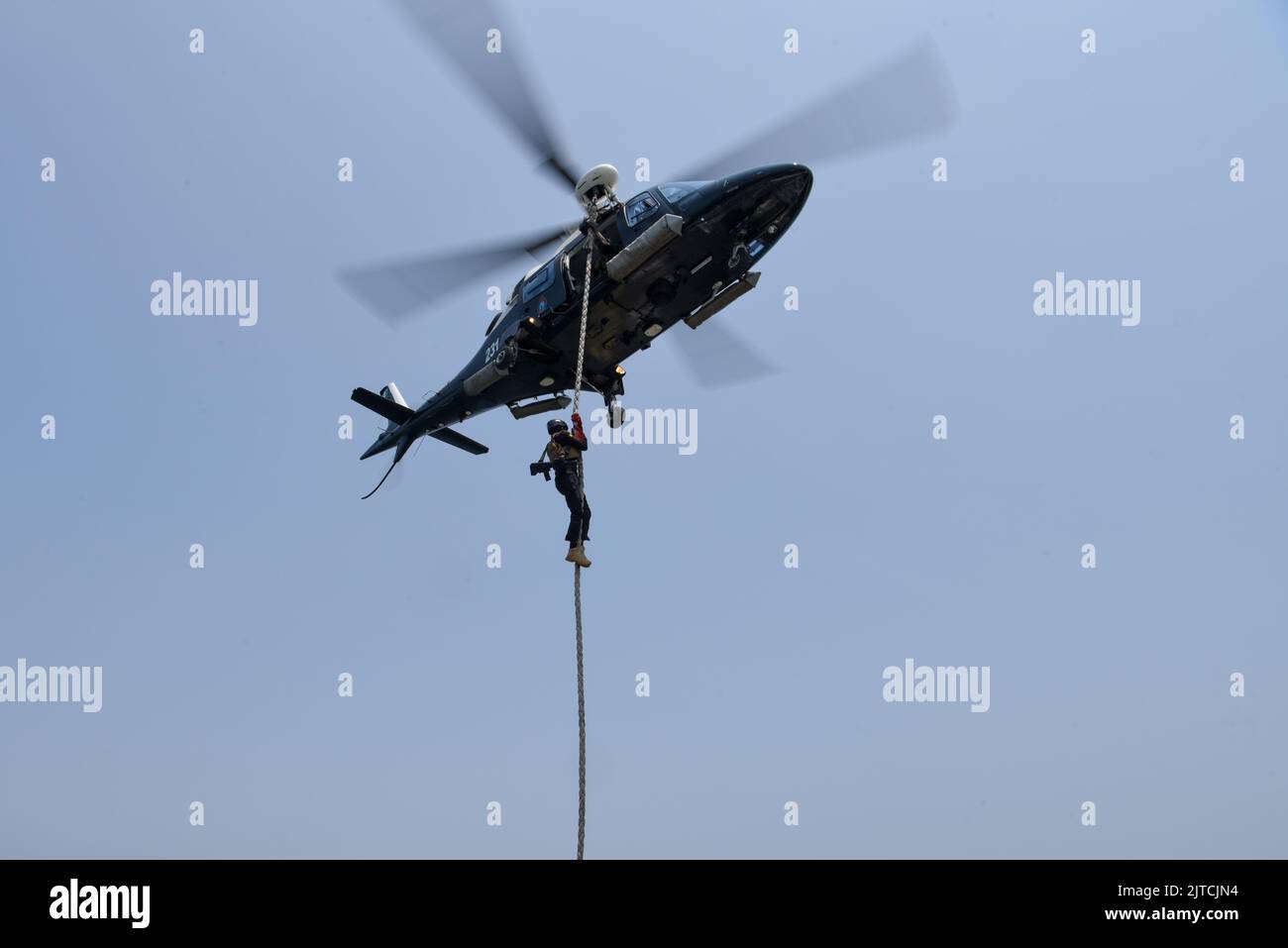 A member of the Nigerian Navy fast-ropes down onto the flight deck of ...