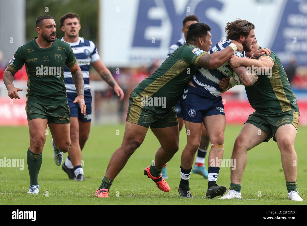 Joe Shorrocks #22 of Wigan Warriors is tackled by Albert Vete #8 and ...