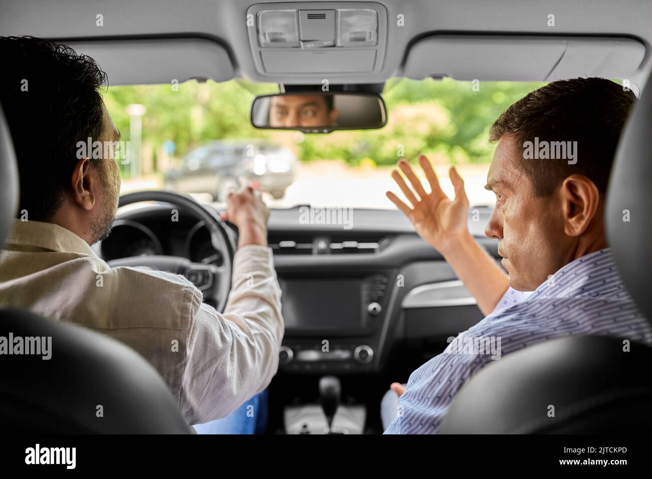 car driving school instructor teaching male driver Stock Photo - Alamy