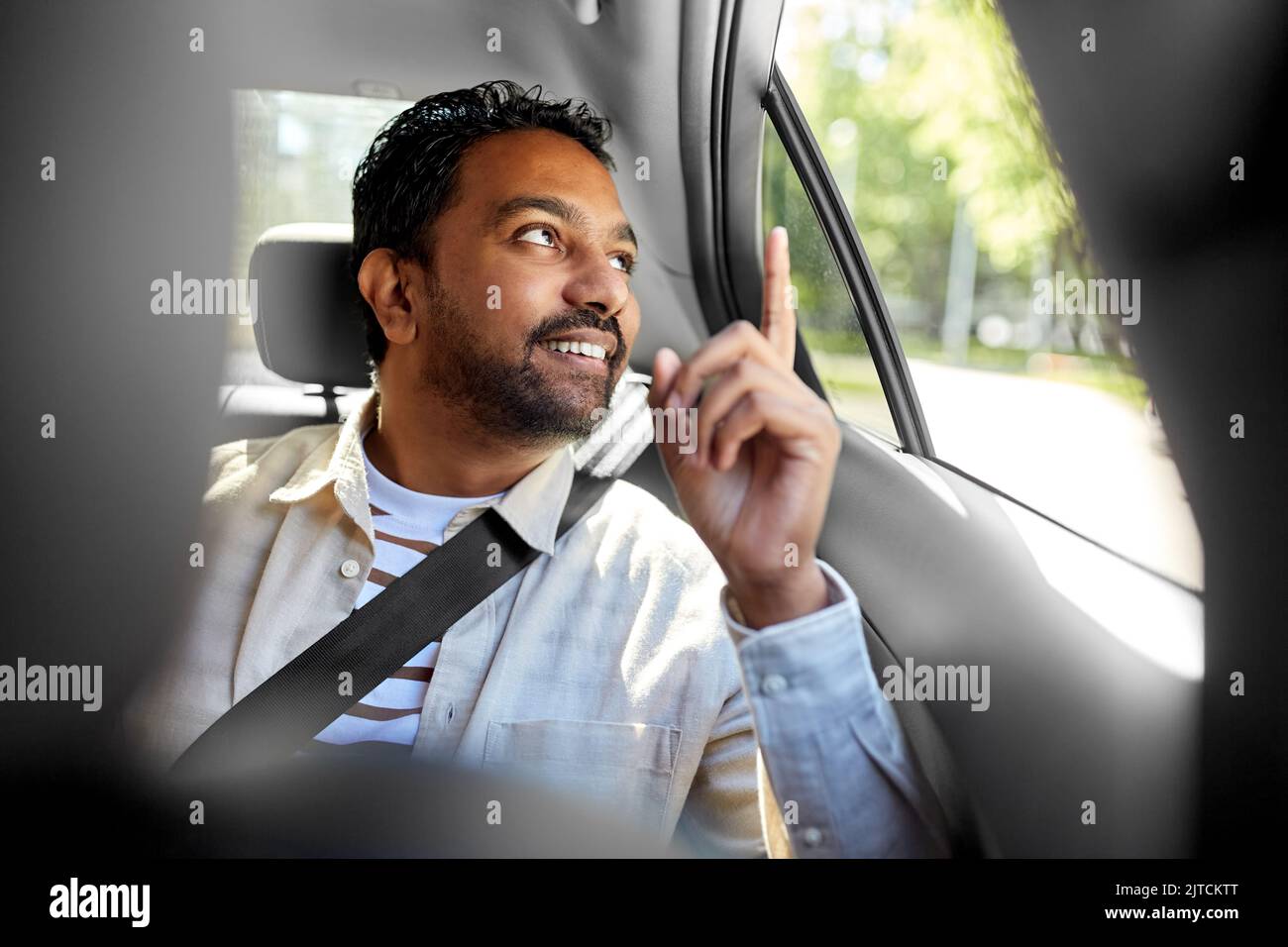 smiling indian male passenger in taxi car Stock Photo - Alamy