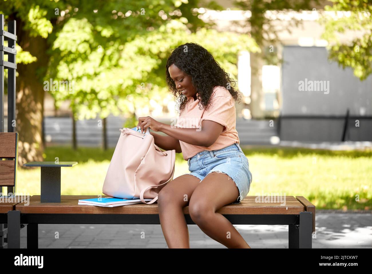 african student girl unpacking backpack in city Stock Photo - Alamy