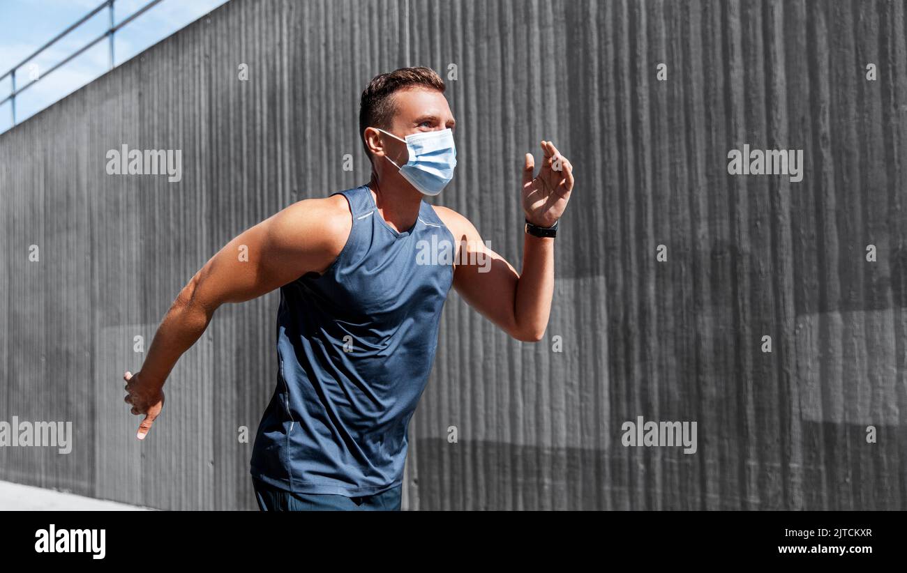 young man in medical mask running outdoors Stock Photo - Alamy