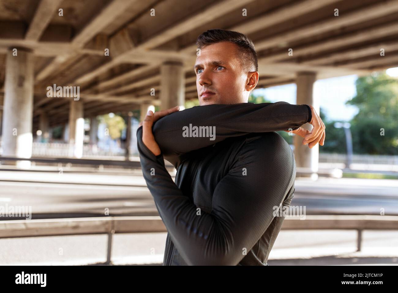 man stretching hand under bridge Stock Photo - Alamy